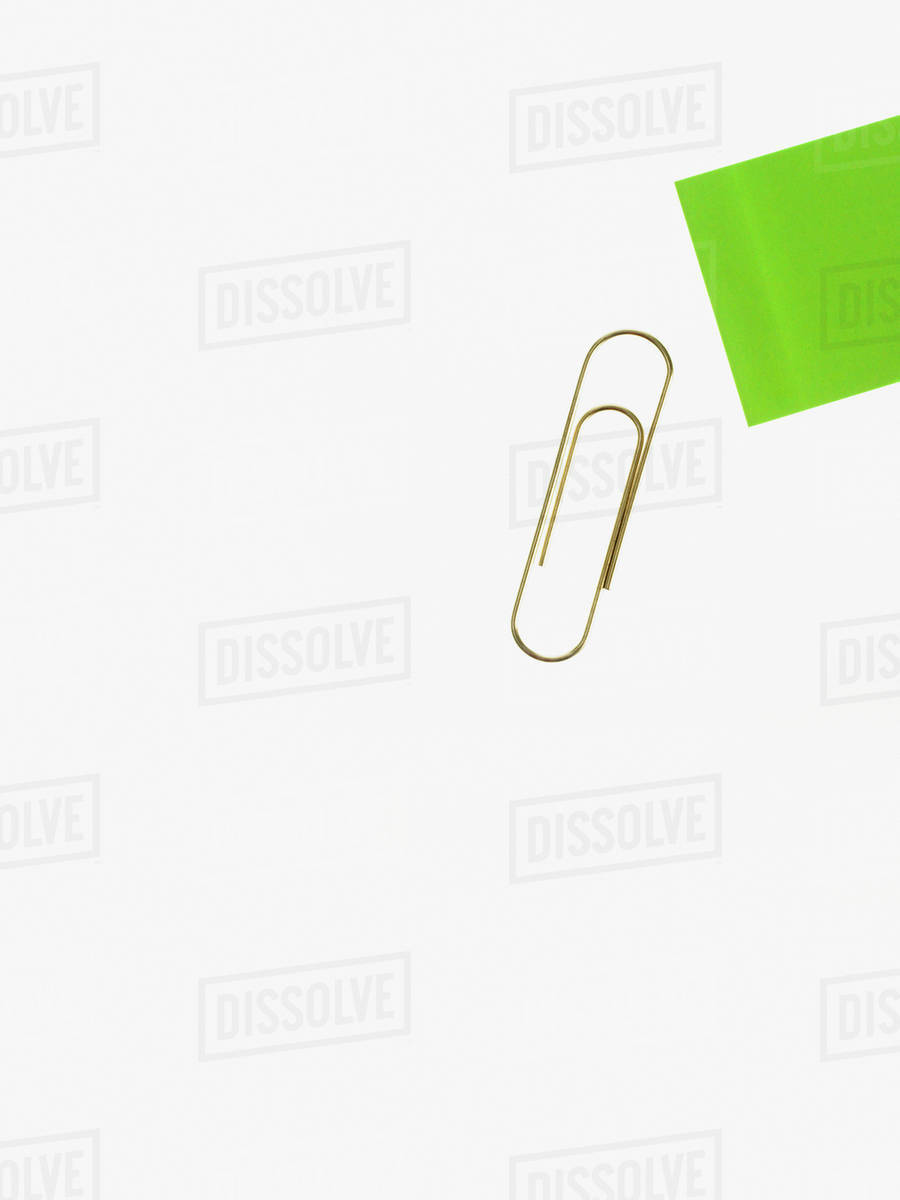 Paper clip and green paper - Stock Photo - Dissolve
