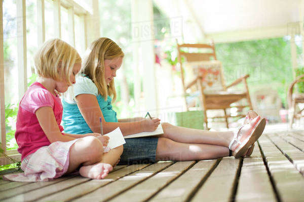 Two girls writing letters - Royalty-free Stock Photo | Dissolve
