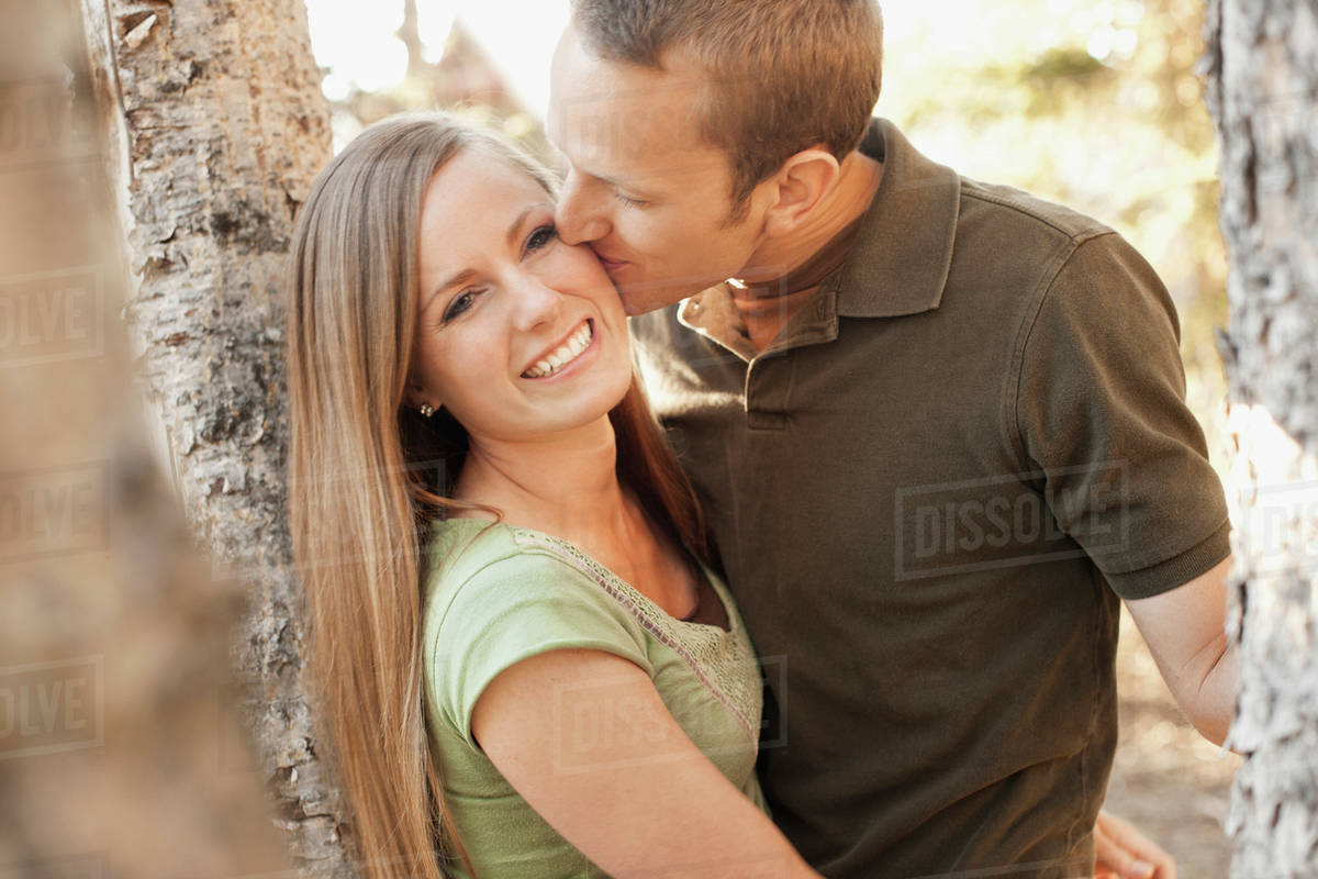 Man kissing his girlfriend - Royalty-free Stock Photo | Dissolve