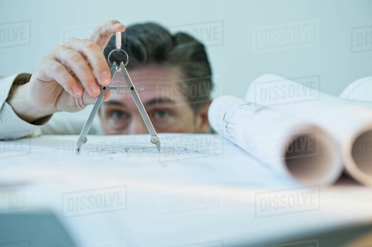 Architect using drawing compass - Royalty-free Stock Photo | Dissolve