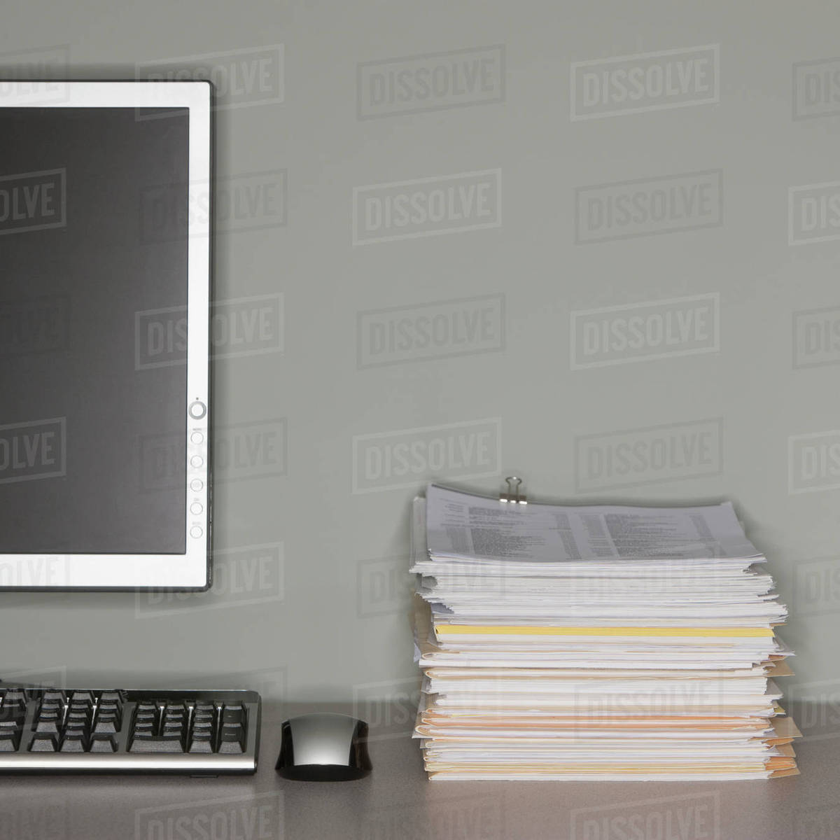 Computer and stack of paperwork - Royalty-free Stock Photo | Dissolve