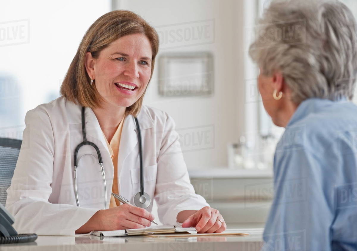 Senior woman talking with female doctor - Royalty-free Stock Photo ...