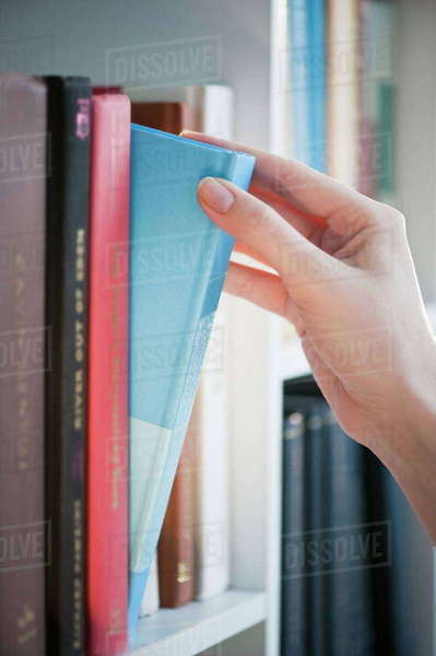 Woman removing book from shelf, close-up - Royalty-free Stock Photo ...