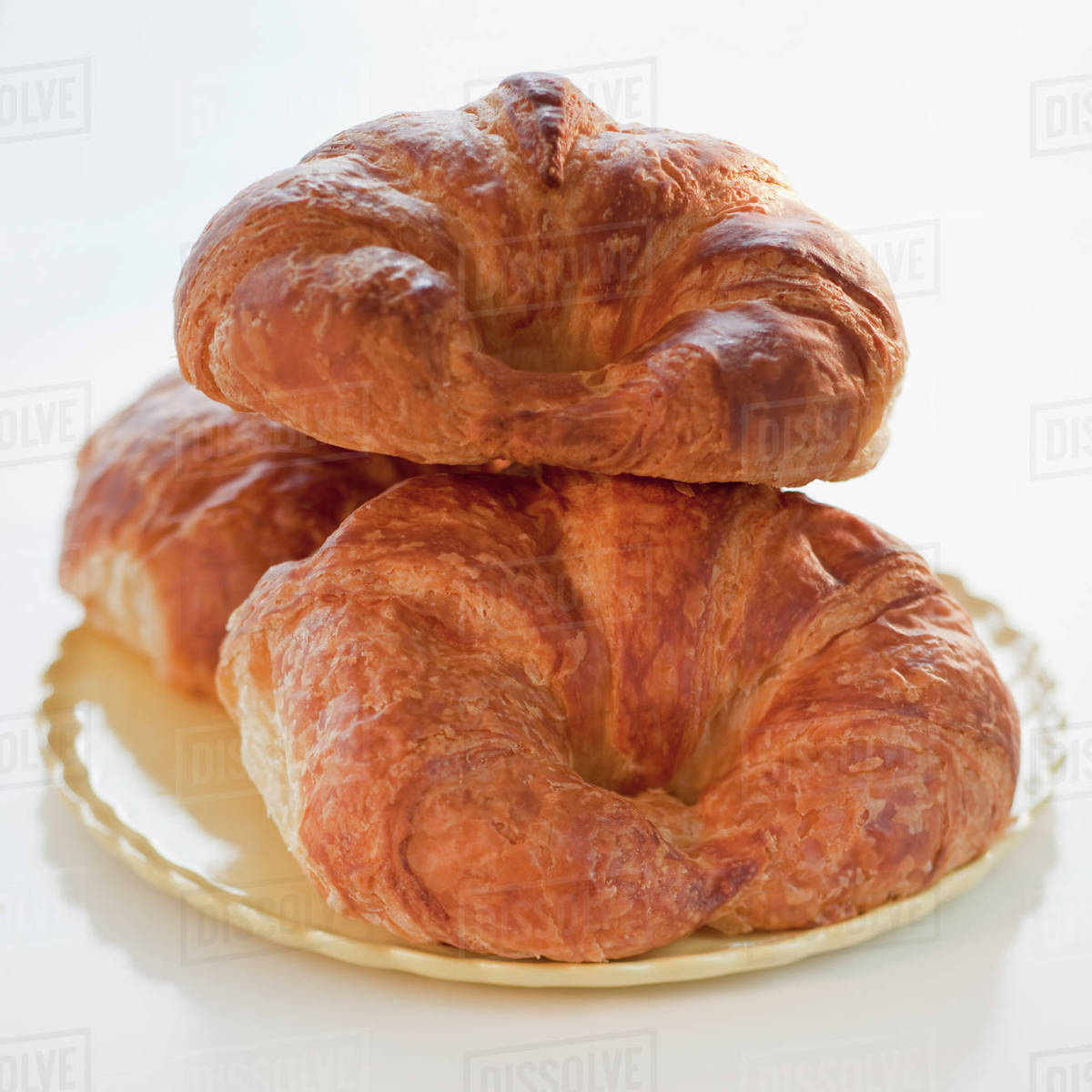 Three croissants on a plate - Royalty-free Stock Photo | Dissolve