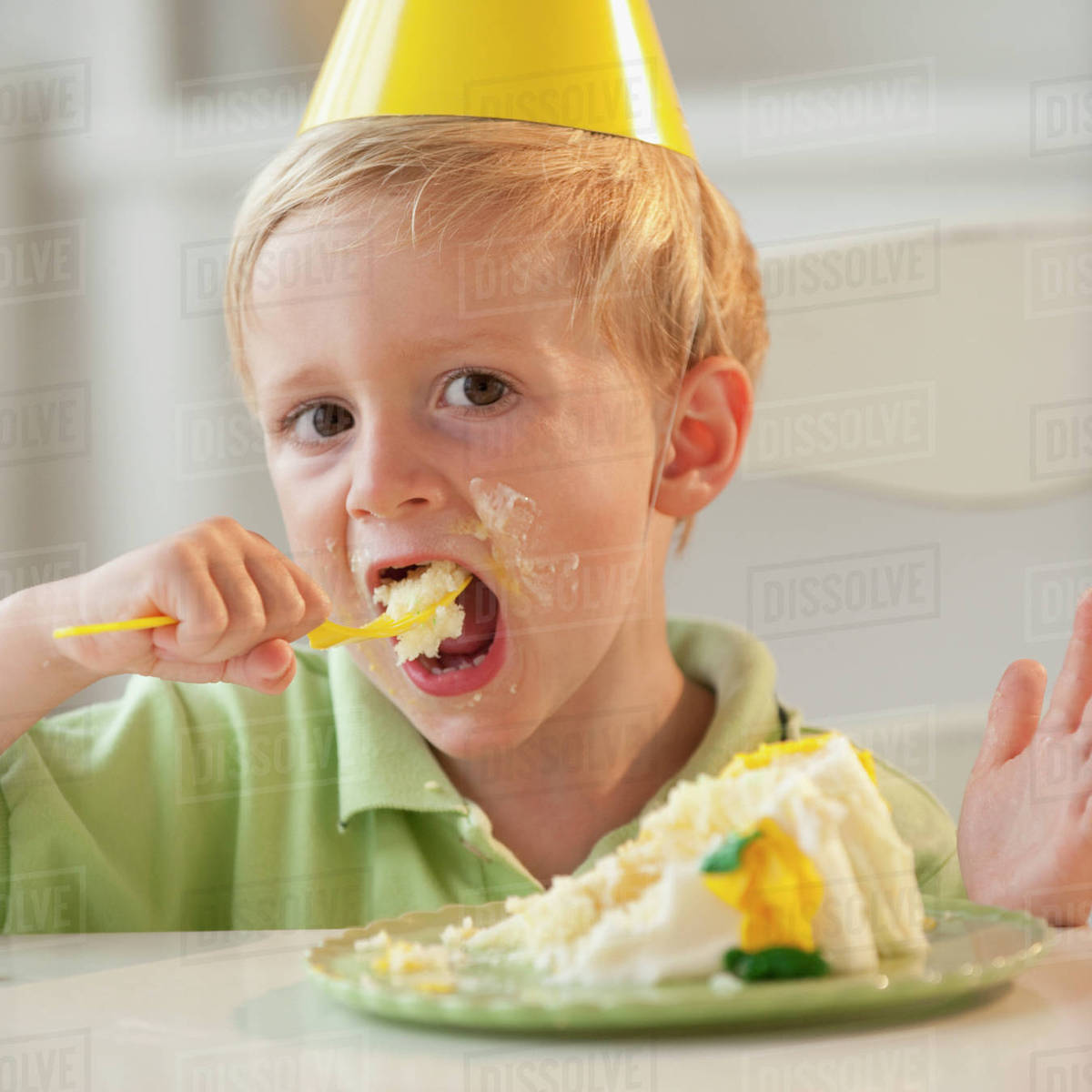 Young child eating birthday cake - Royalty-free Stock Photo | Dissolve