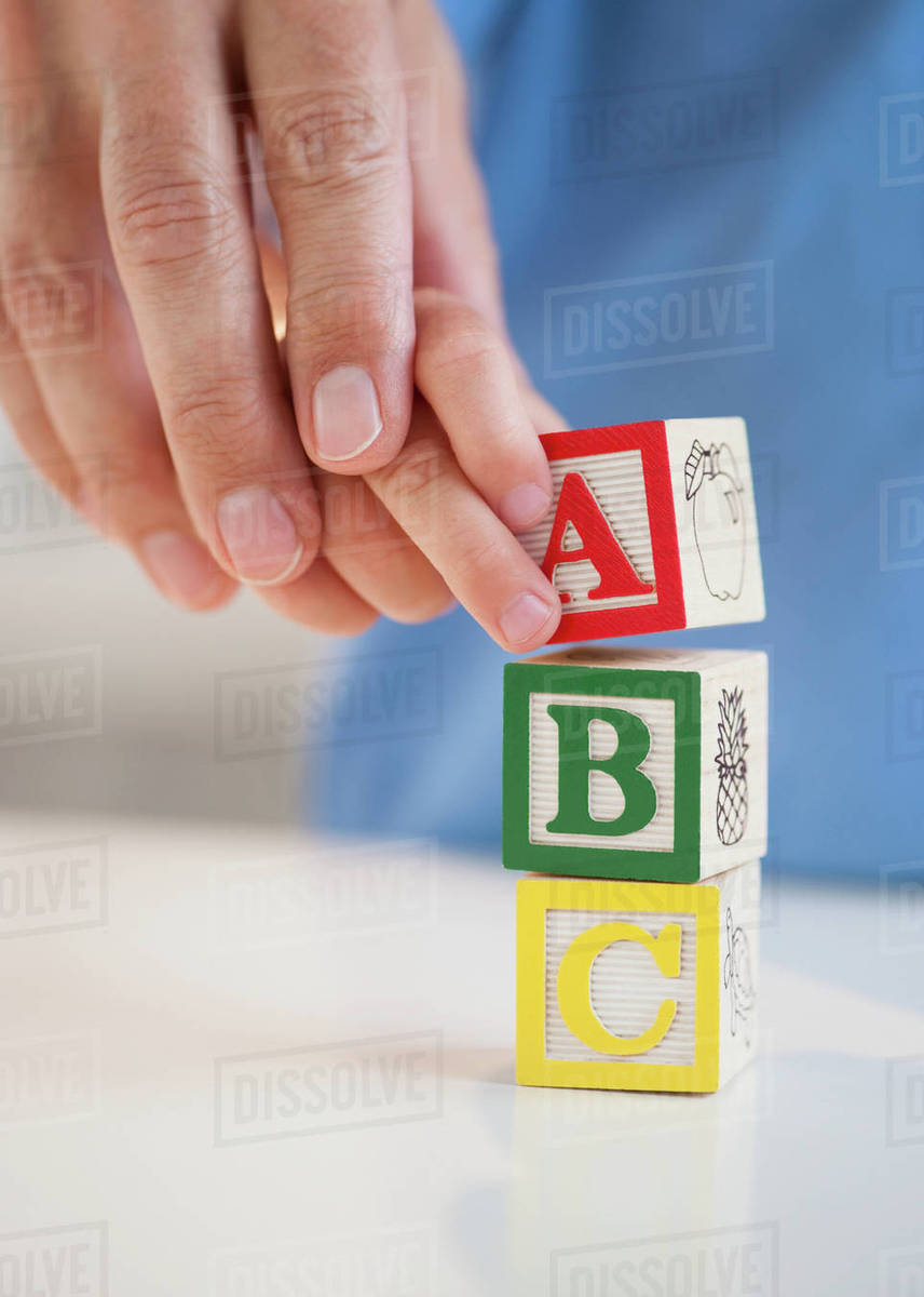 Child playing with ABC blocks - Royalty-free Stock Photo | Dissolve