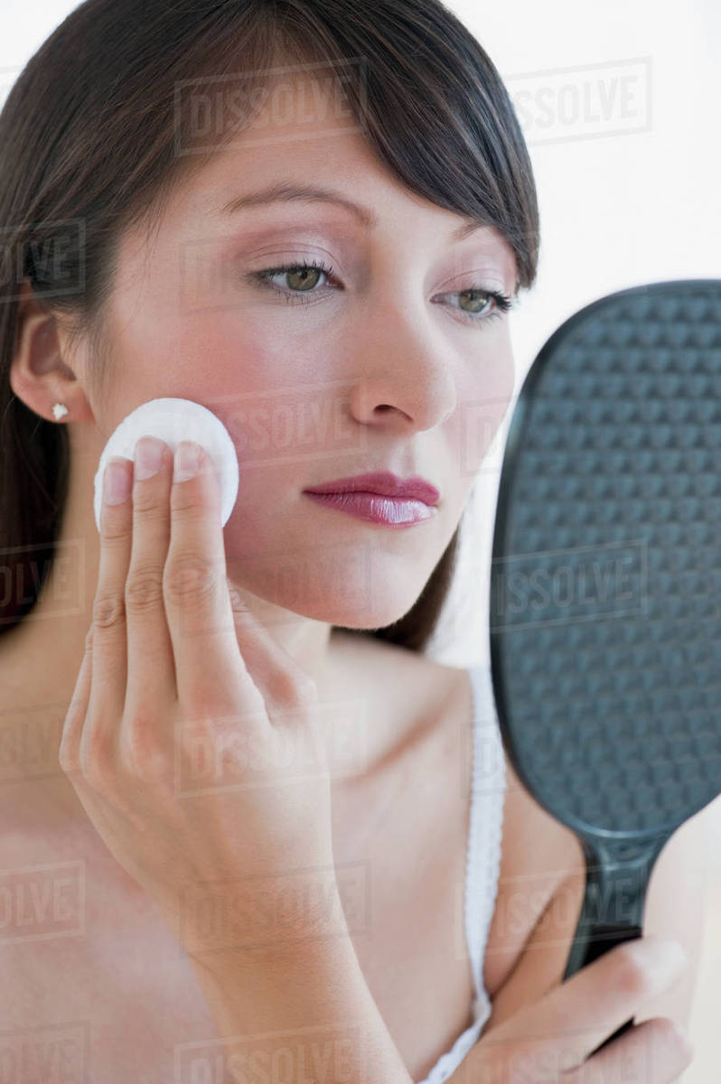 Woman applying makeup - Stock Photo - Dissolve