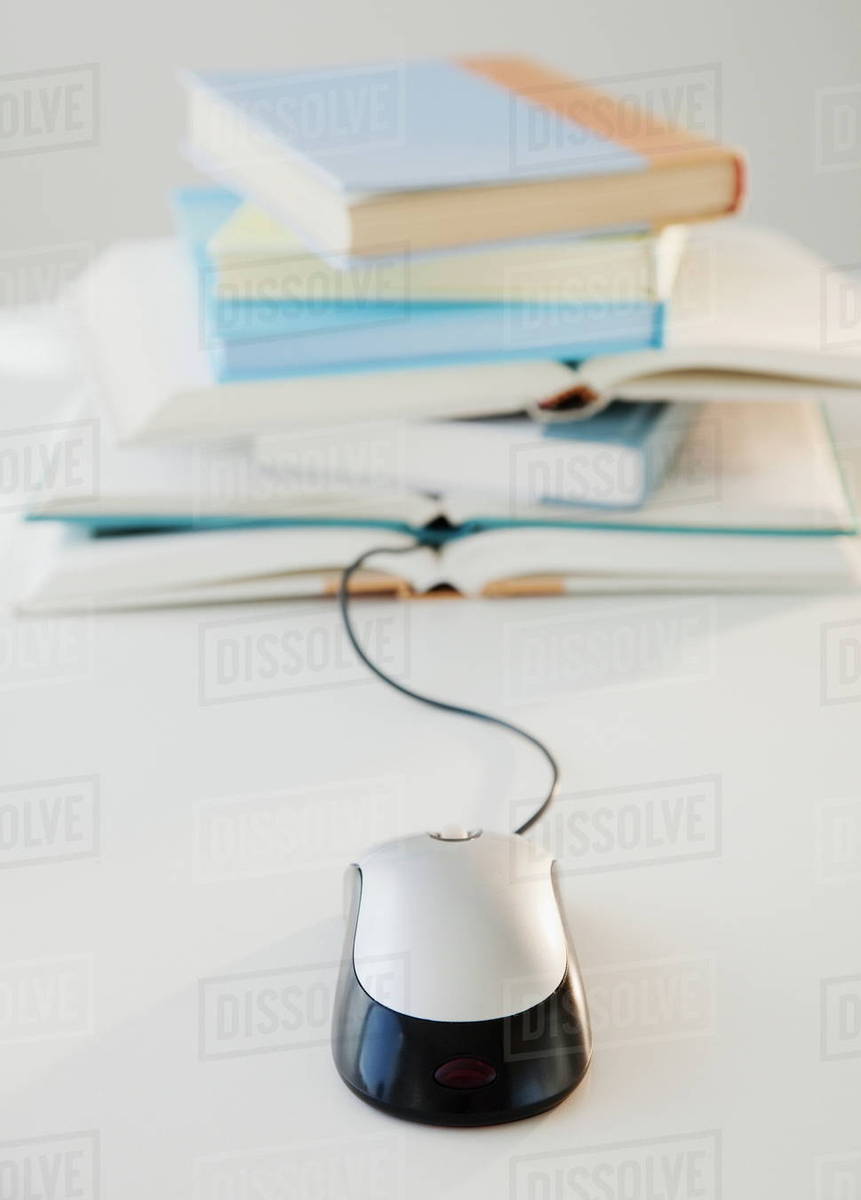 Computer mouse near pile of books, studio shot - Royalty-free Stock ...