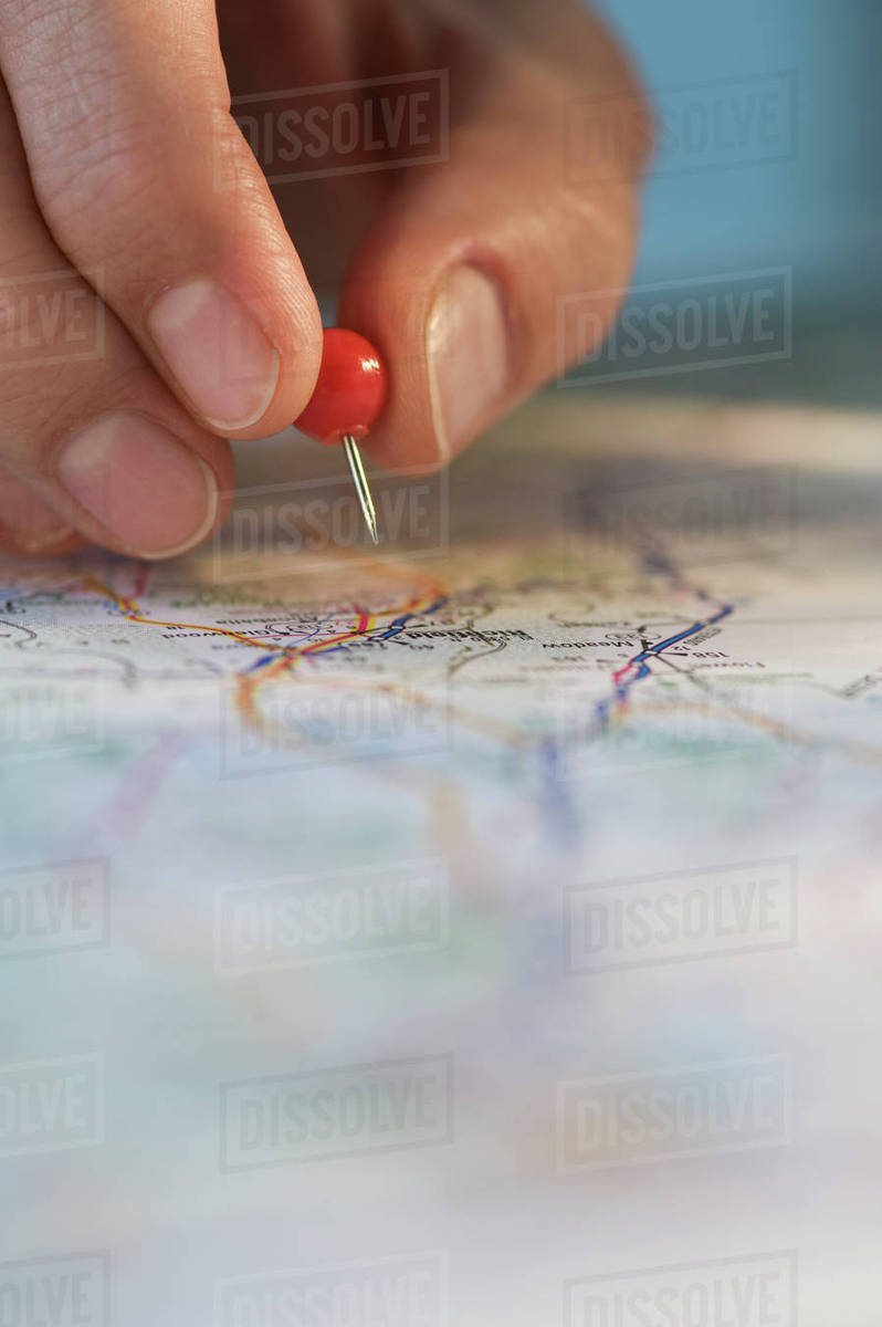 Man marking location on map - Royalty-free Stock Photo | Dissolve
