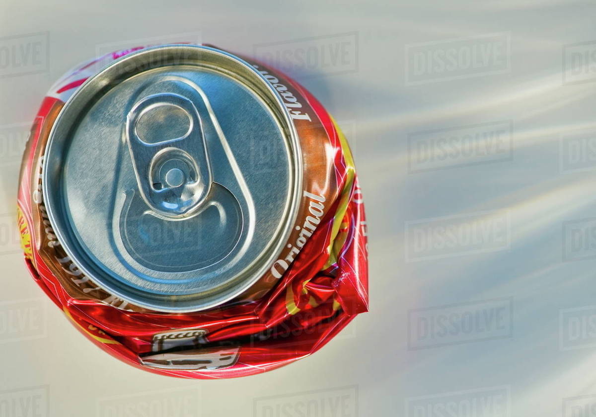 Crushed can for recycling, studio shot - Stock Photo - Dissolve