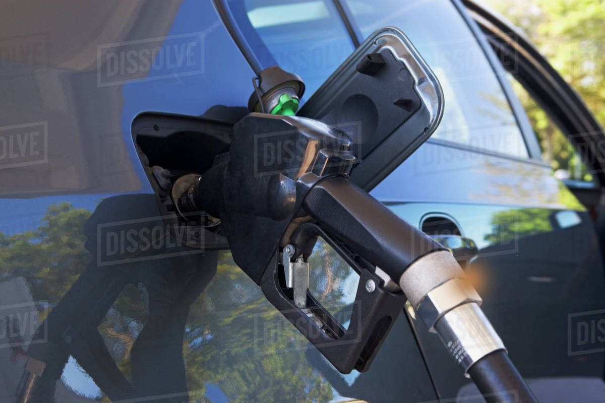 Close up of gas pump in car - Stock Photo - Dissolve