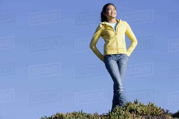 Teenage girl standing on hill - Royalty-free Stock Photo | Dissolve