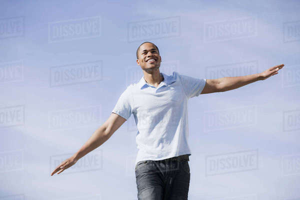 A man outdoors with arms out - Stock Photo - Dissolve
