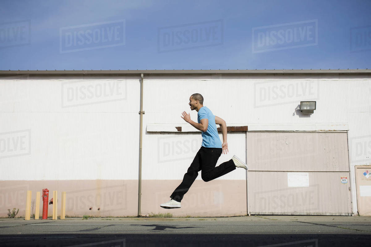 A man jumping on a road - Royalty-free Stock Photo | Dissolve