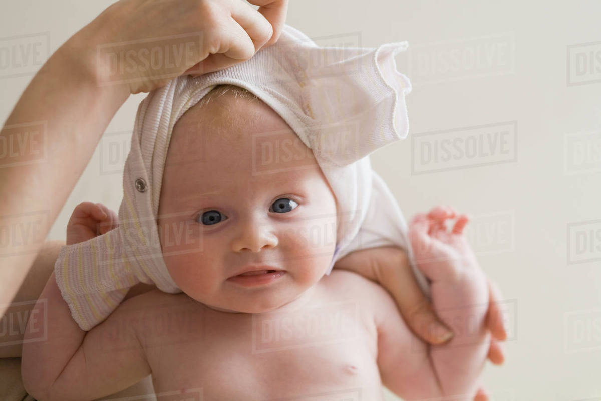 Hand changing baby's clothes - Royalty-free Stock Photo | Dissolve