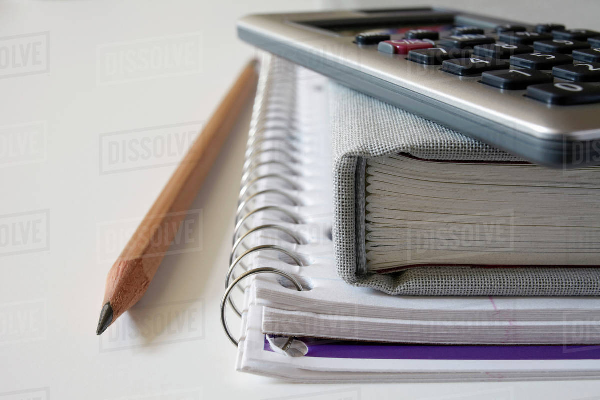 Calculator, textbook and pencil on notebook, studio shot - Royalty-free ...