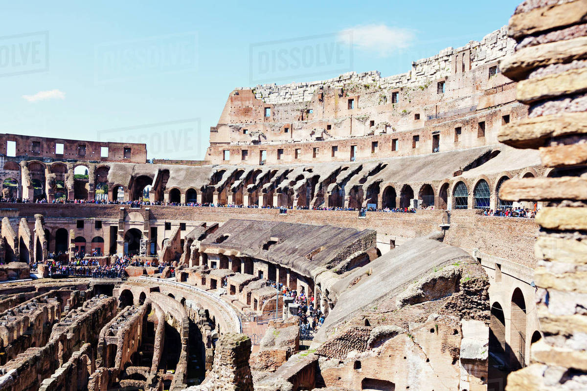Ruins of Coliseum under blue sky - Stock Photo - Dissolve