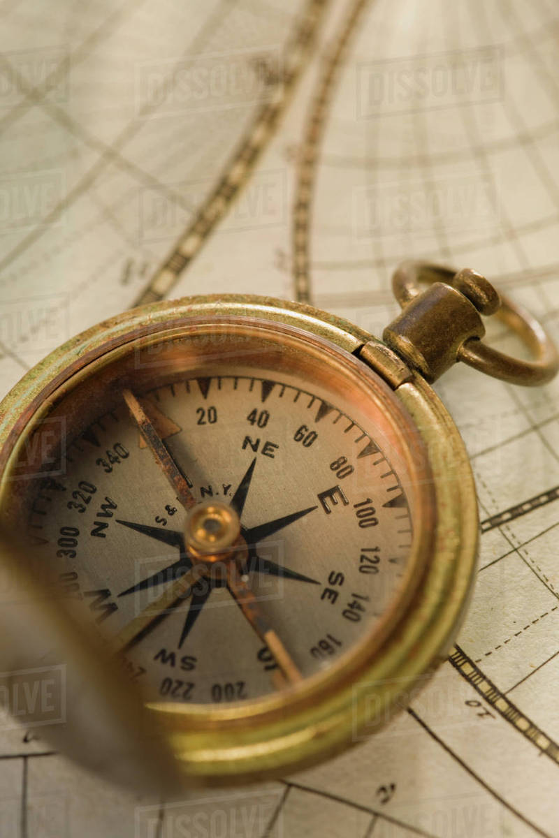 Compass on antique map - Stock Photo - Dissolve