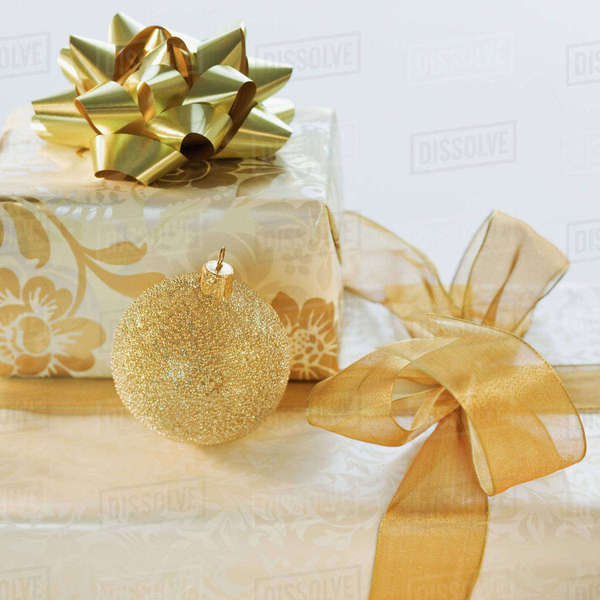 Ornament on pile of gifts - Royalty-free Stock Photo | Dissolve