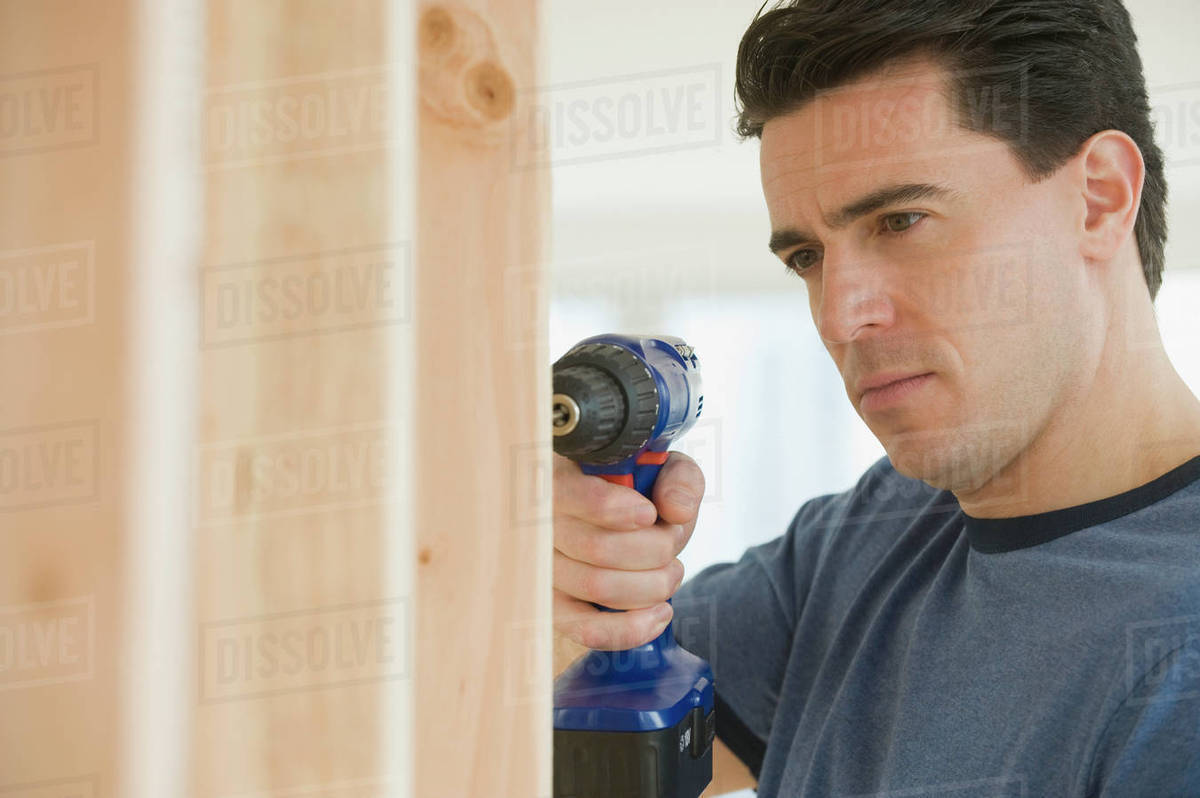 Man using cordless drill - Royalty-free Stock Photo | Dissolve