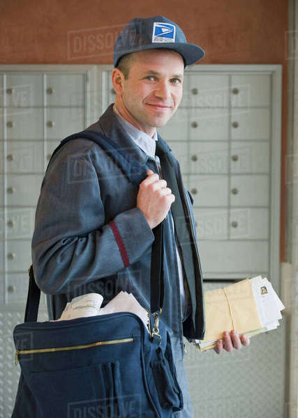 Male postal worker carrying mailbag - Royalty-free Stock Photo | Dissolve