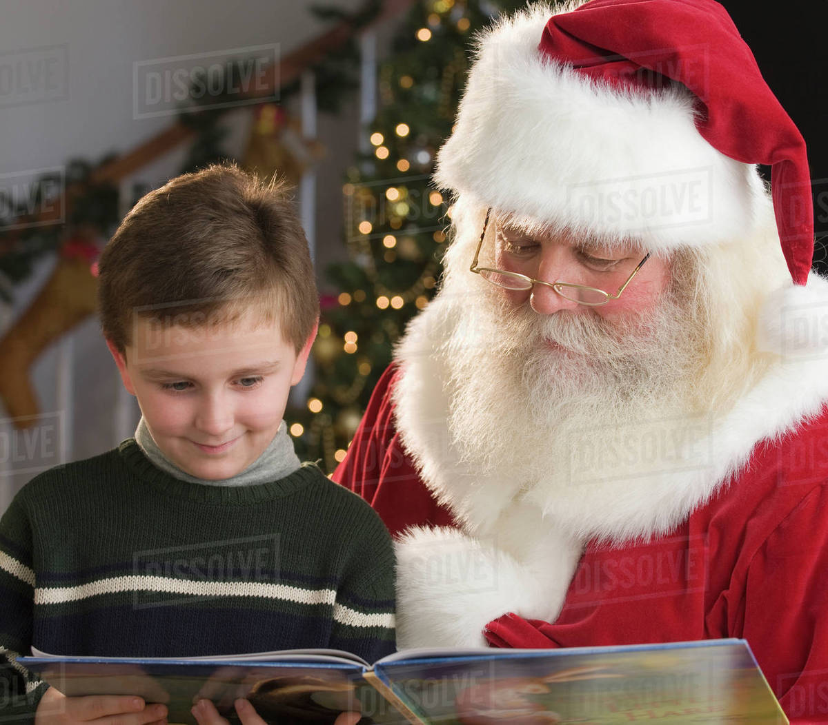 Santa Claus and boy reading book - Royalty-free Stock Photo | Dissolve