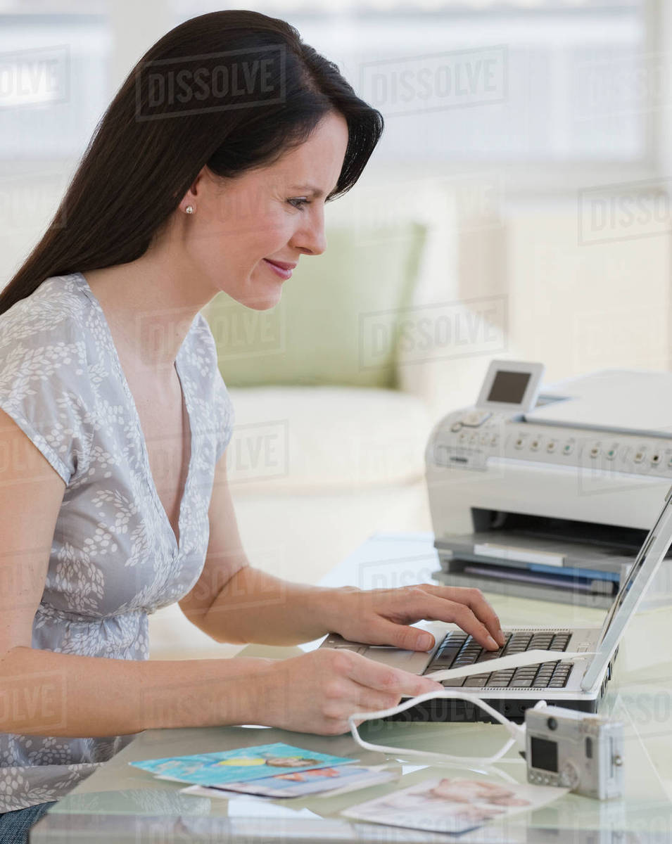 Woman typing on laptop - Stock Photo - Dissolve