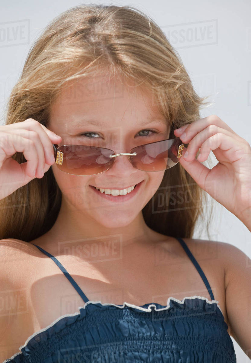 Girl looking over sunglasses - Royalty-free Stock Photo | Dissolve