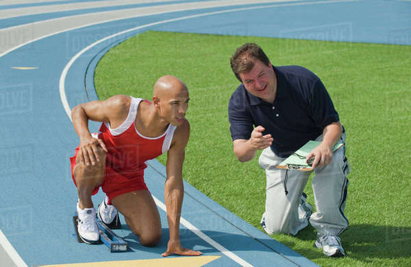 Coach giving runner advise - Stock Photo - Dissolve