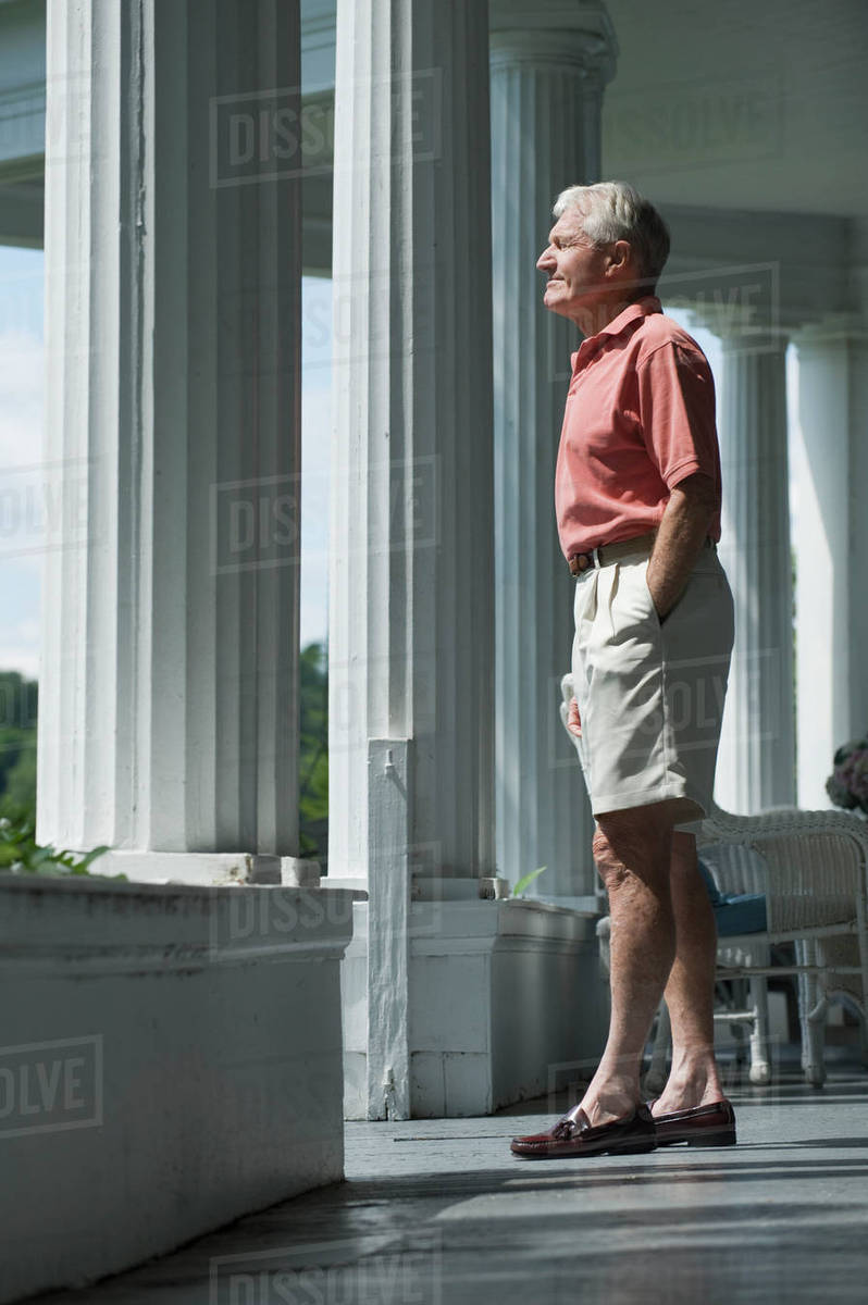 Senior man standing on porch - Royalty-free Stock Photo | Dissolve