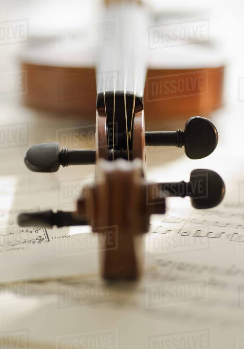 Close up of violin bow on sheet music - Stock Photo - Dissolve