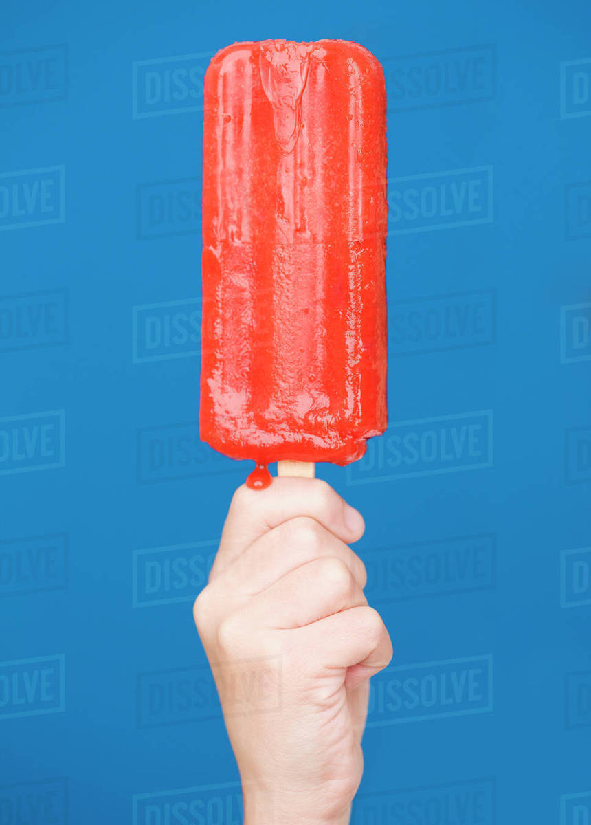 Child holding ice pop - Royalty-free Stock Photo | Dissolve