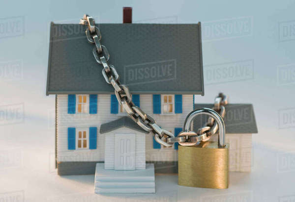 Model house locked with chain - Stock Photo - Dissolve