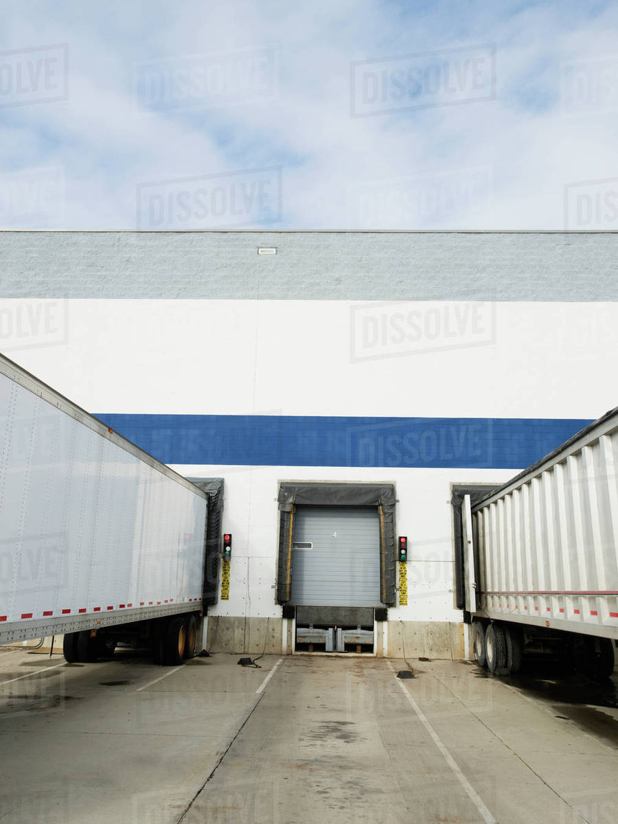 Trucks parked at loading dock - Royalty-free Stock Photo | Dissolve
