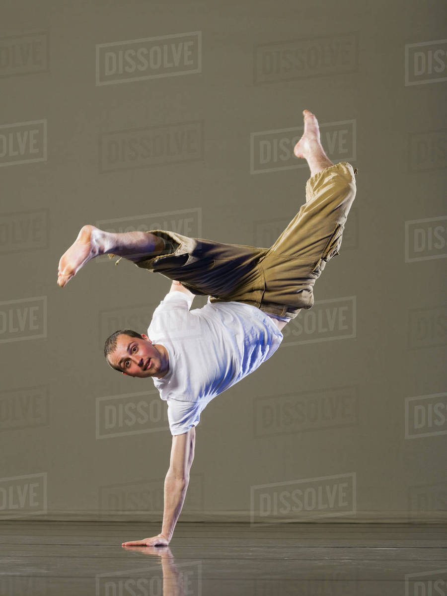 Man balancing on one hand - Royalty-free Stock Photo | Dissolve