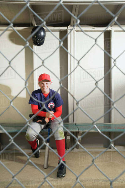 Baseball player sitting in dugout - Royalty-free Stock Photo | Dissolve