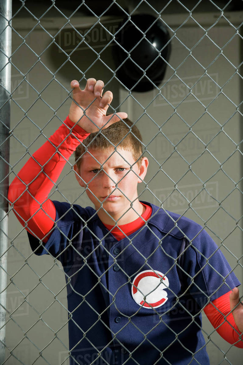 Serious baseball player standing in dugout - Royalty-free Stock Photo ...