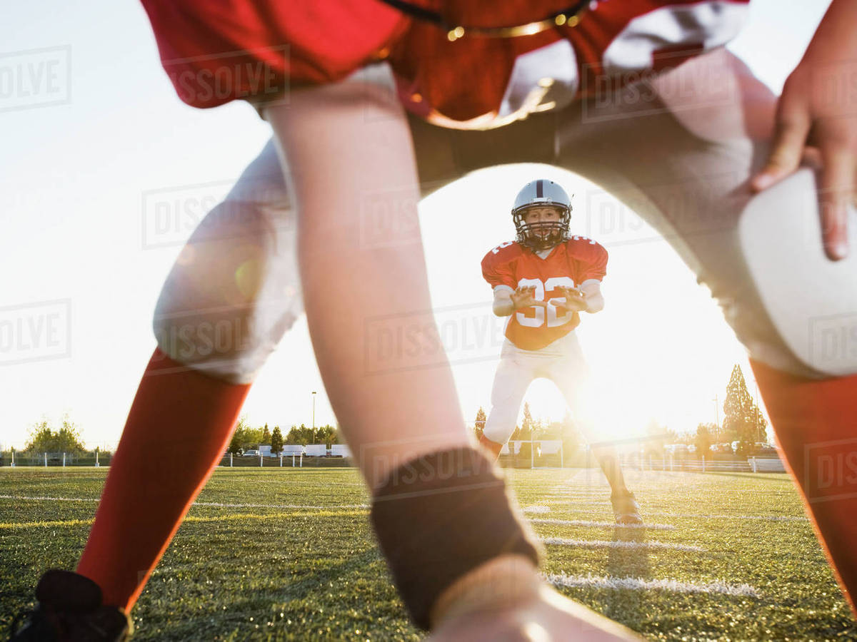 Football center preparing to snap football to quarterback - Stock Photo ...