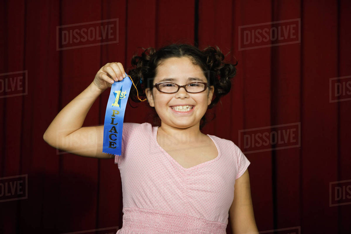 Girl holding first place ribbon on stage - Royalty-free Stock Photo ...