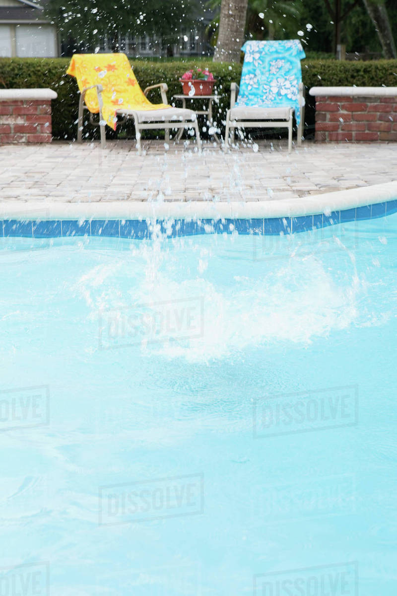 Big splash in swimming pool - Royalty-free Stock Photo | Dissolve