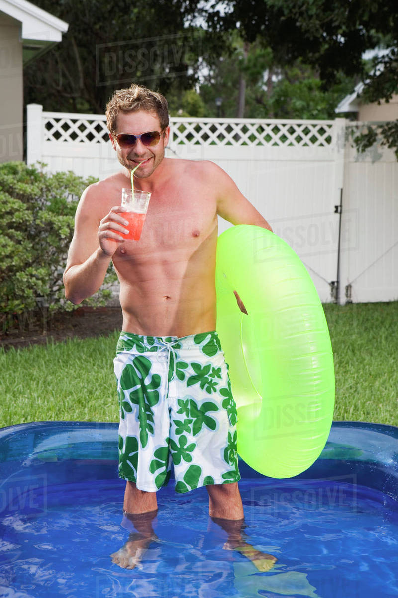 Man standing in inflatable swimming pool - Royalty-free Stock Photo ...