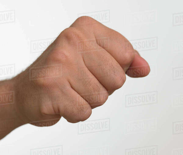 Studio shot of man's hand making fist - Royalty-free Stock Photo | Dissolve