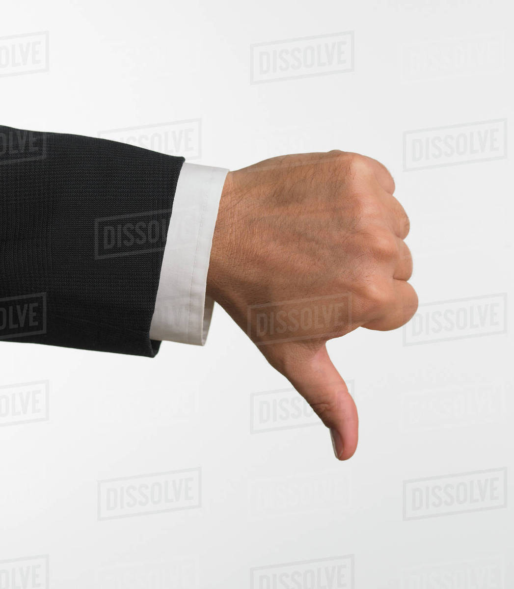 Studio shot of businessman's hand giving thumbs down - Stock Photo ...