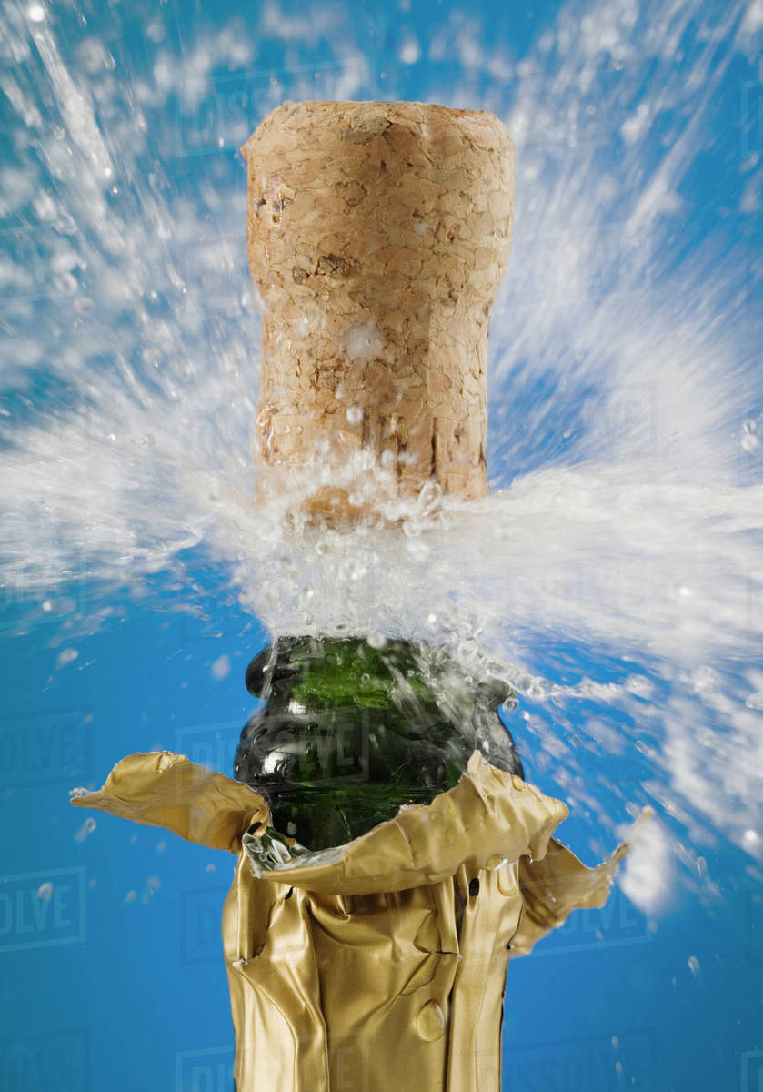 Close up of champagne cork popping - Stock Photo - Dissolve