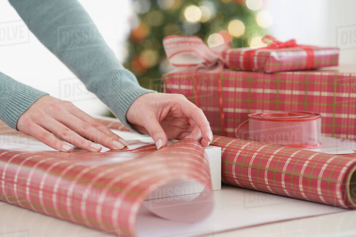 Woman wrapping Christmas gifts - Royalty-free Stock Photo | Dissolve
