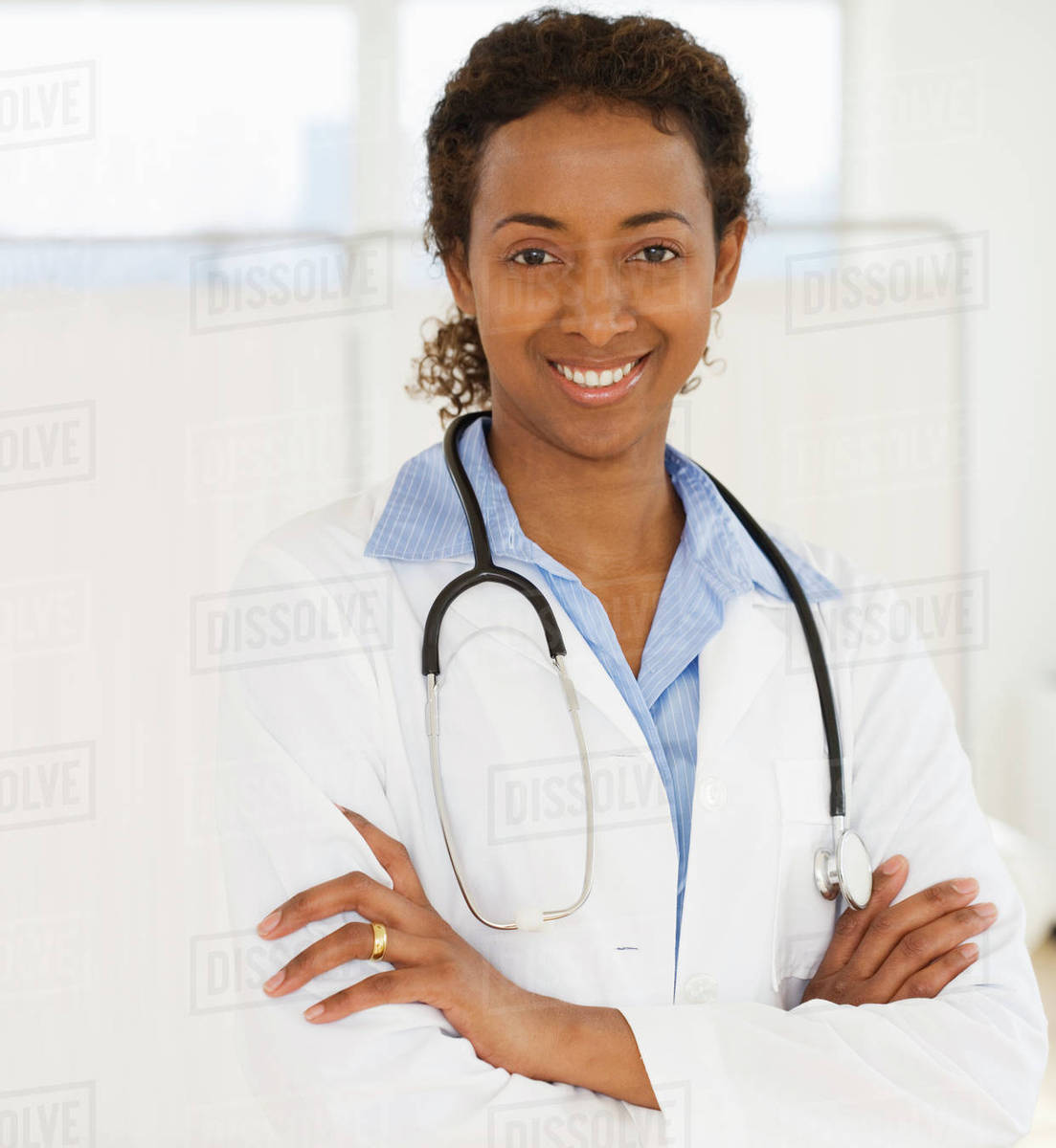 Portrait of female doctor with arms crossed - Royalty-free Stock Photo ...
