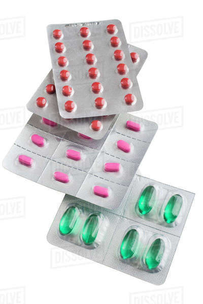 Assorted medication in bubble packs - Stock Photo - Dissolve
