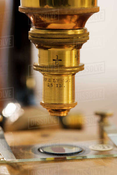 Close up of old fashioned microscope - Stock Photo - Dissolve