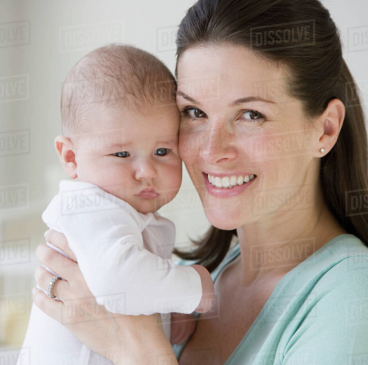 Mother hugging baby - Stock Photo - Dissolve