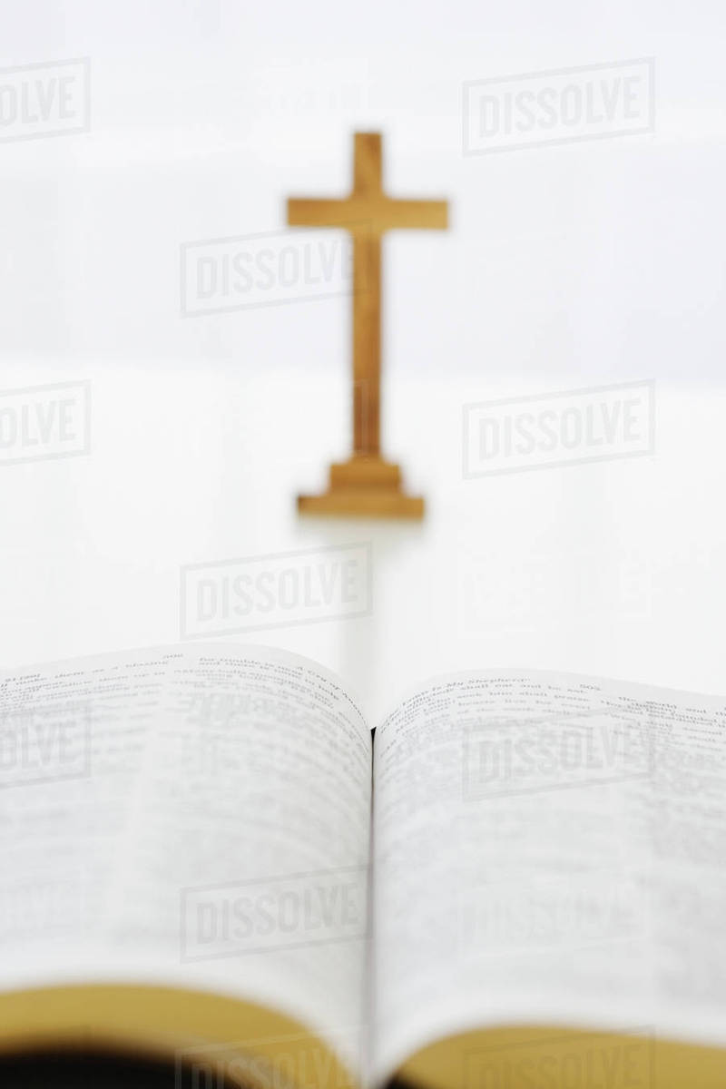 Open book and cross in background - Stock Photo - Dissolve